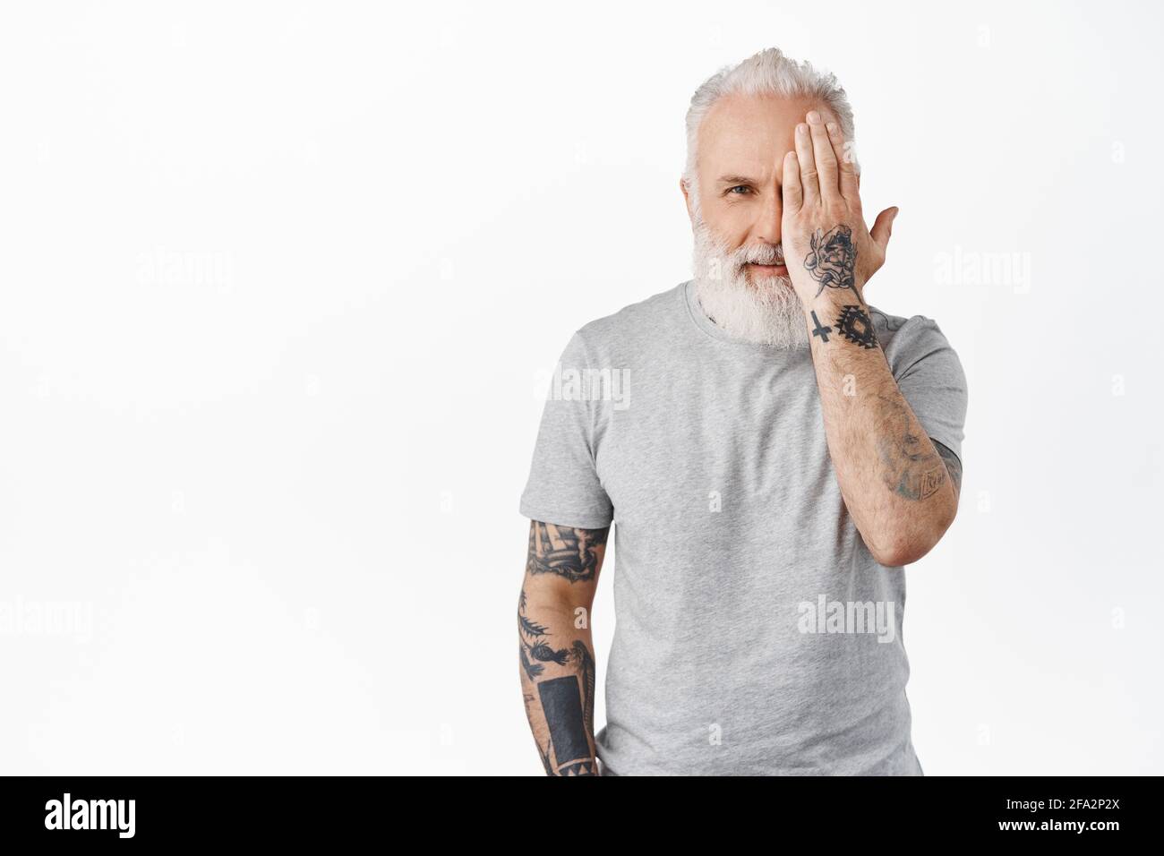 Senior man cover one eye and half face, checking vision in optician ...