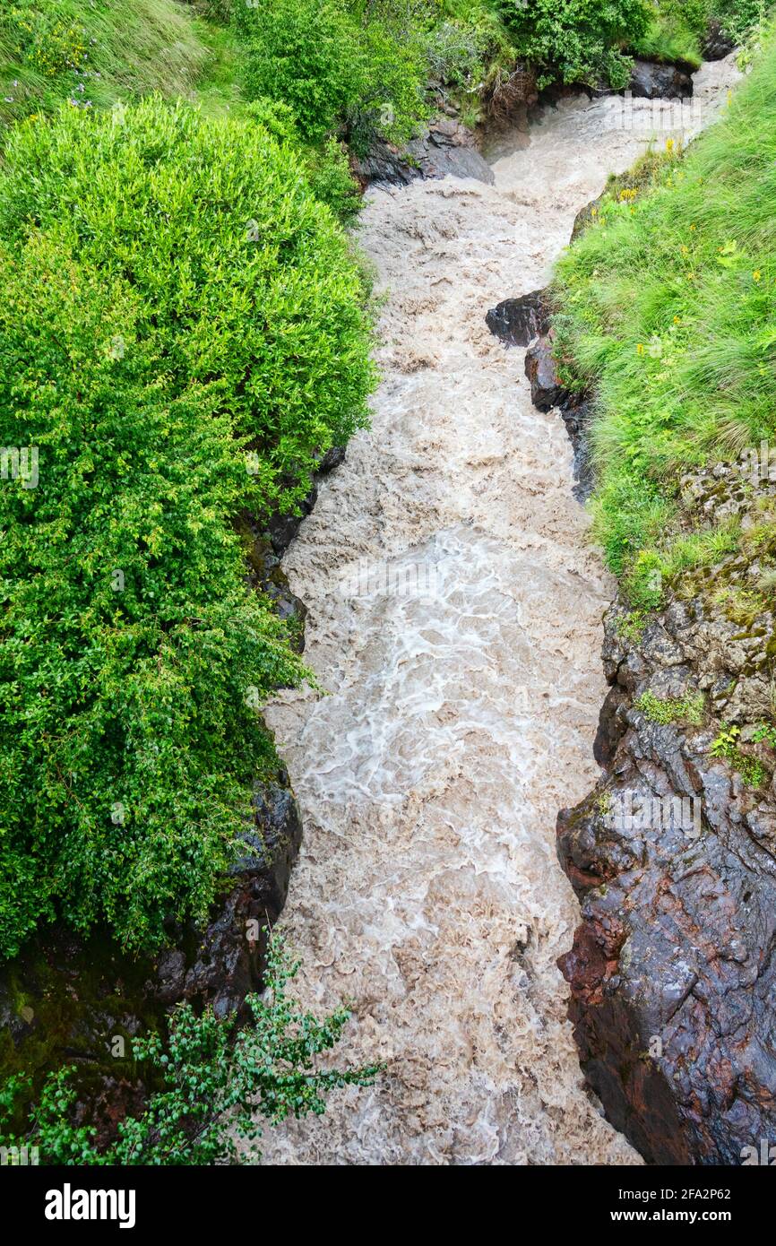 A powerful stream of water is squeezed between the sides of the rocks ...