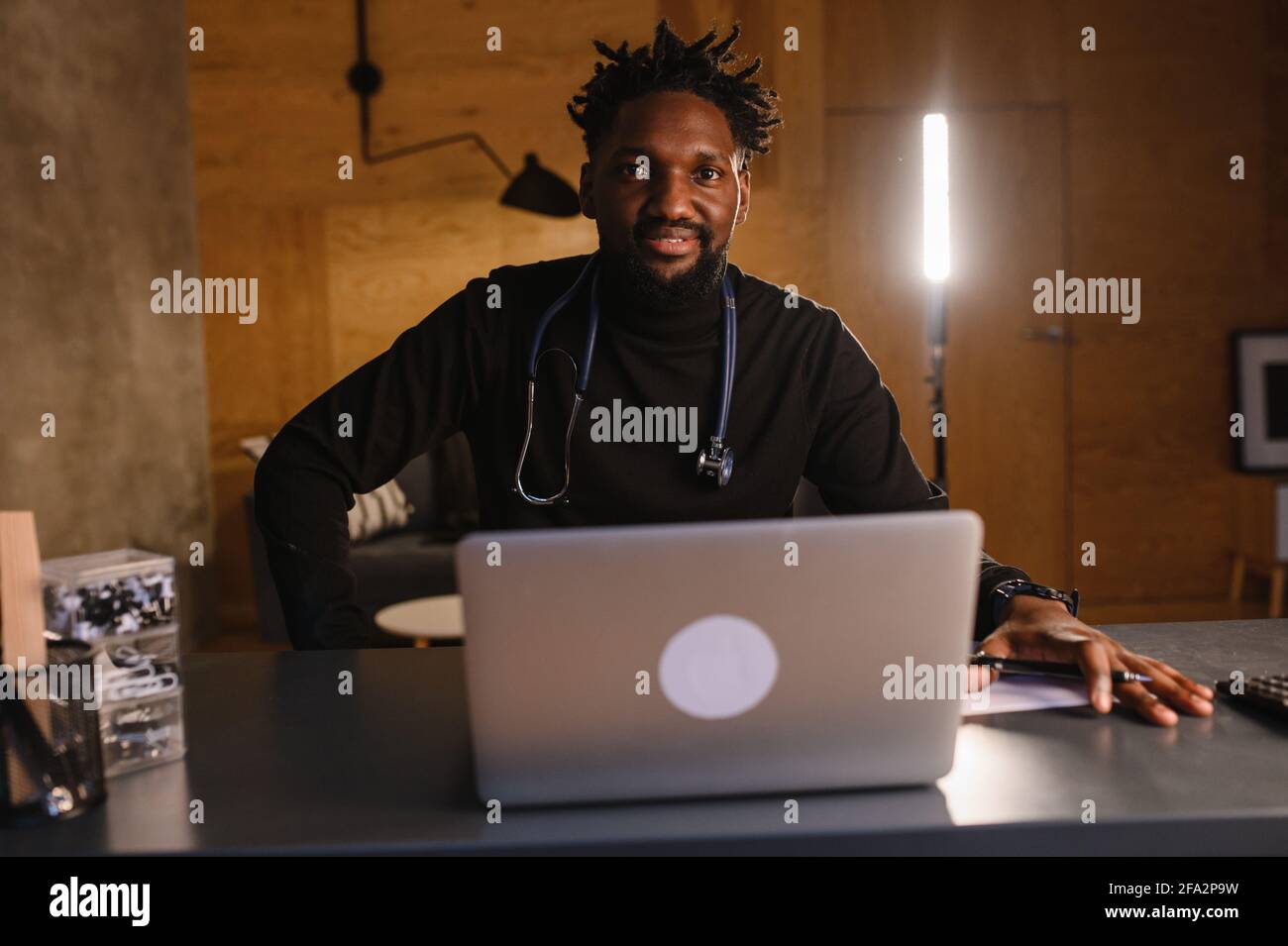 Black doctor. Telemedicine the use of computer and telecommunications ...