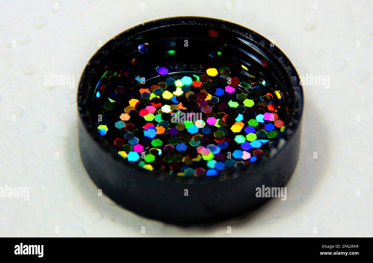 Holographic glitter on the lens of a camera isolated on white ...