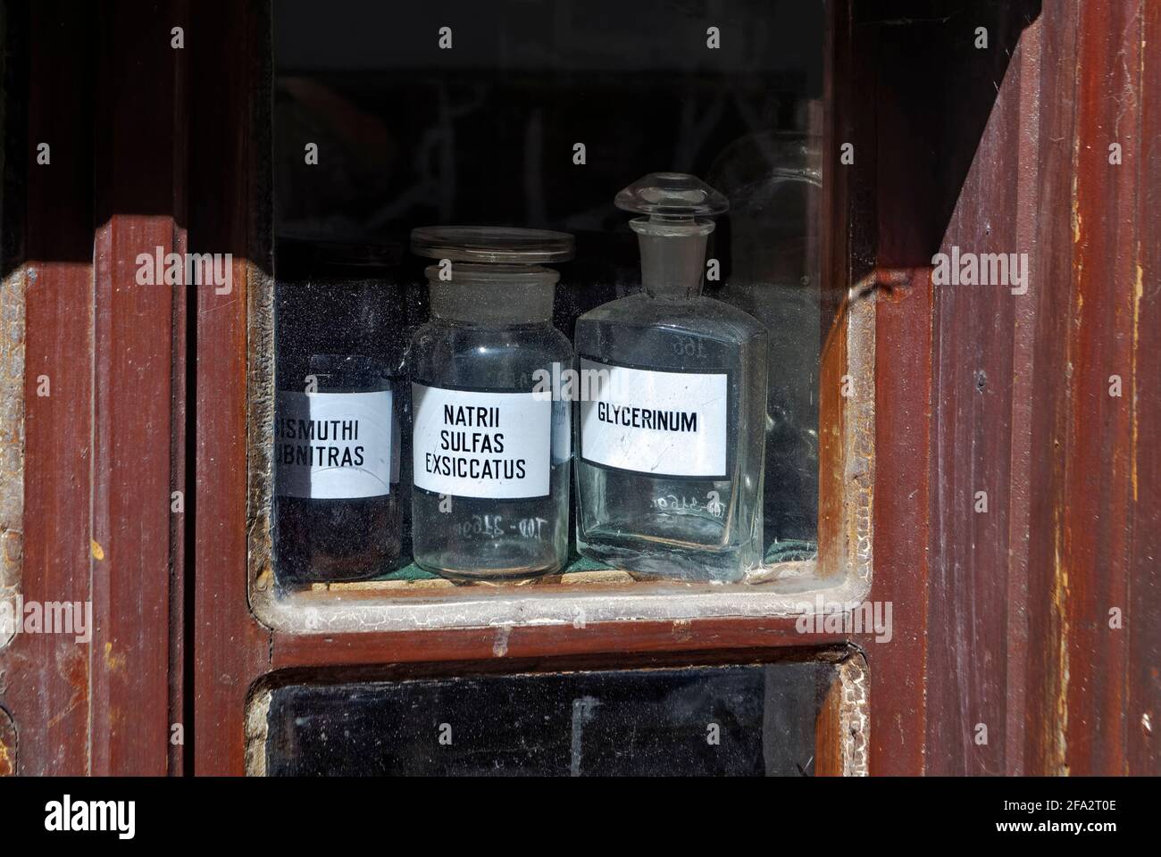 glass bottles on a dirty window of an old drugstore Stock Photo - Alamy