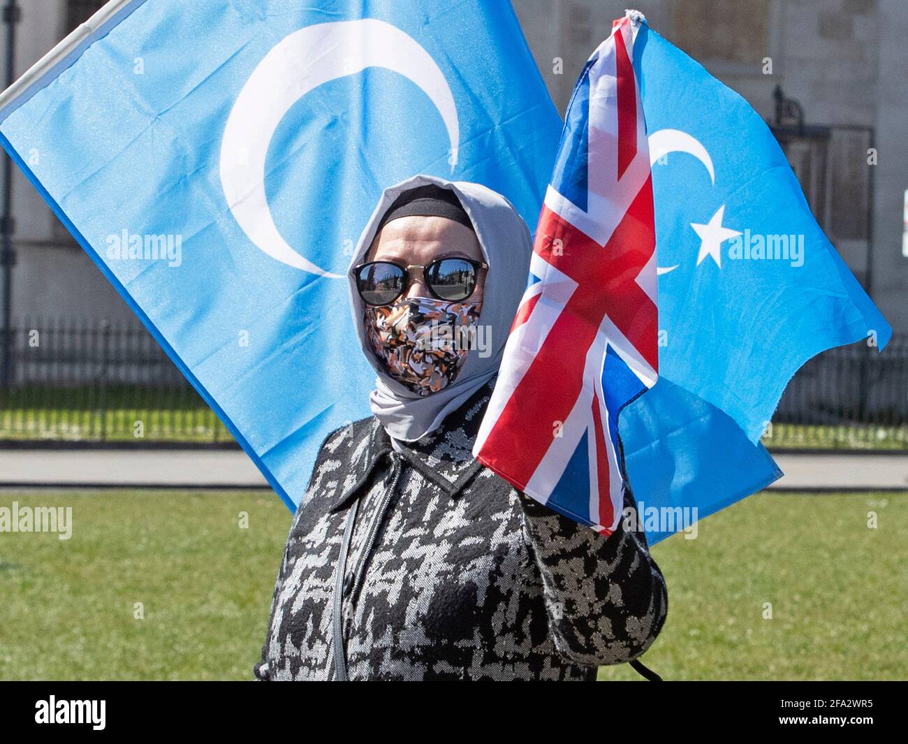 People from the Uyghur Solidarity group protest outside the Houses of ...