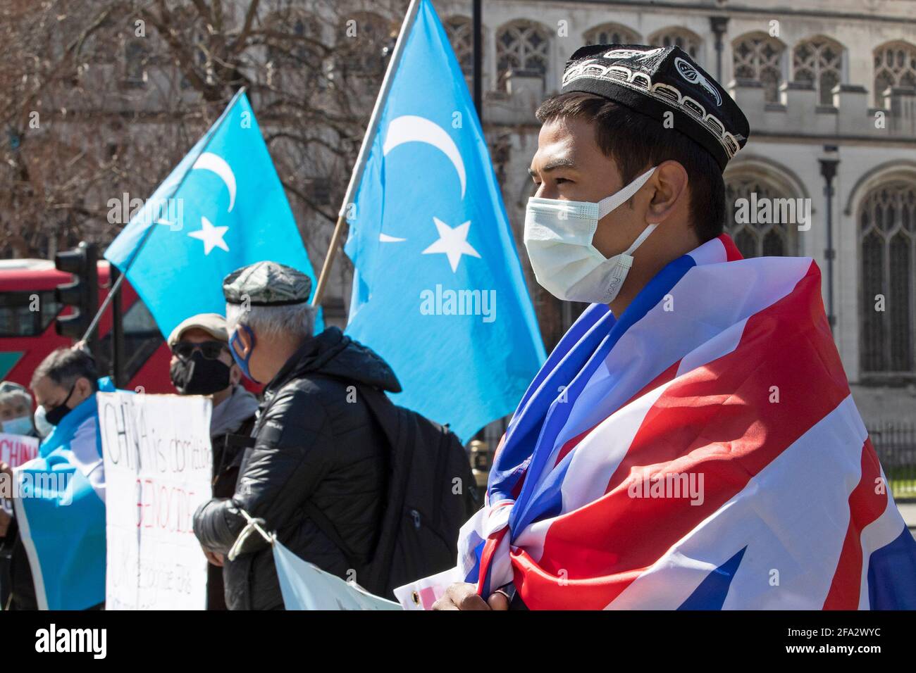 People from the Uyghur Solidarity group protest outside the Houses of ...