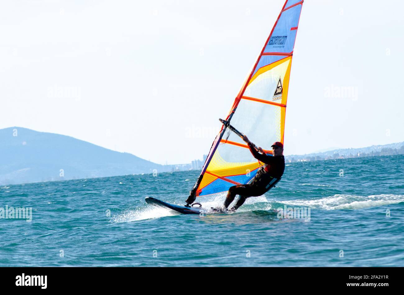 Windsurfing in the evening on a longboard at Stock Photo - Alamy