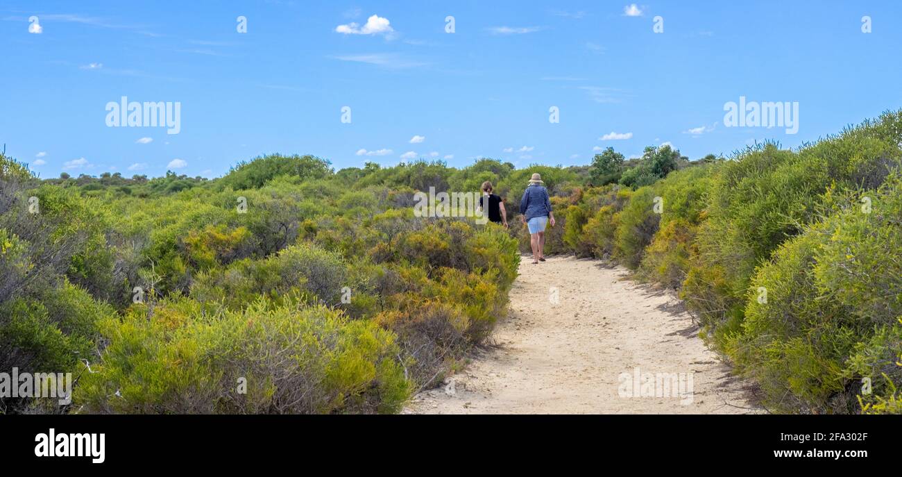 Two Caucasian women walking on a path around Lake Thetis Western ...