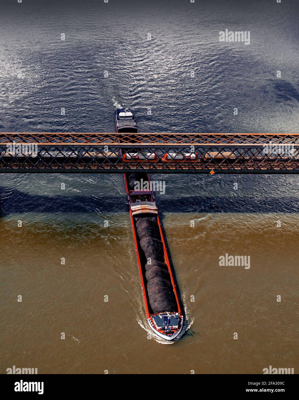 Barge under train bridge Stock Photo - Alamy