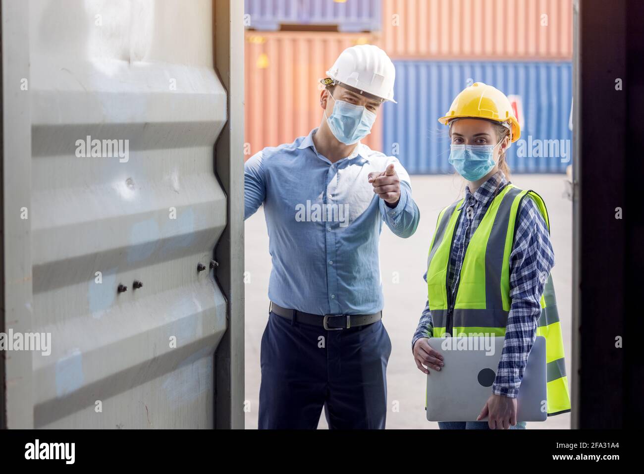 Industrial worker woman and engineer control worker checking in front ...