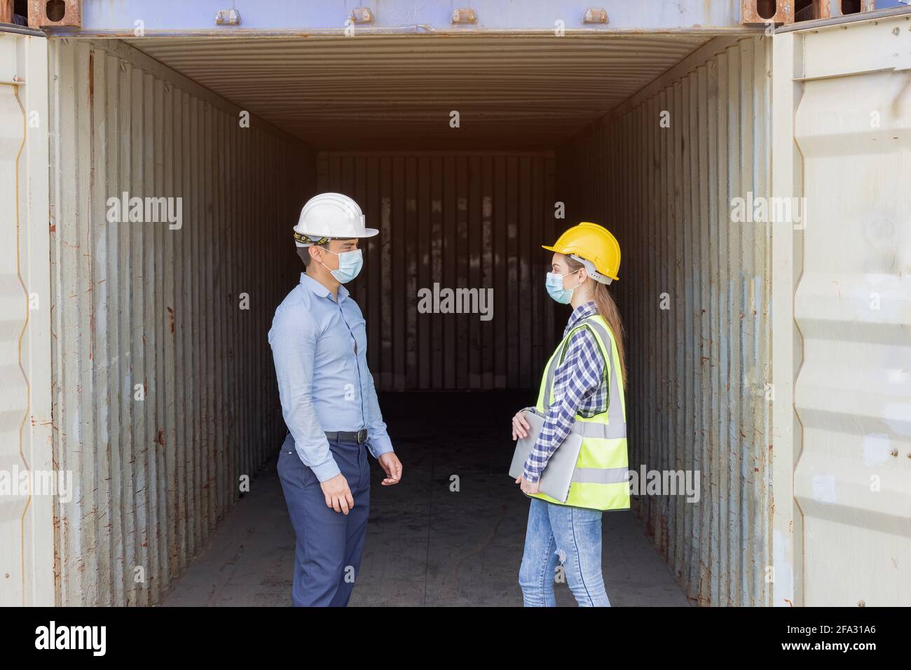 Industrial worker woman and engineer control worker checking in front ...