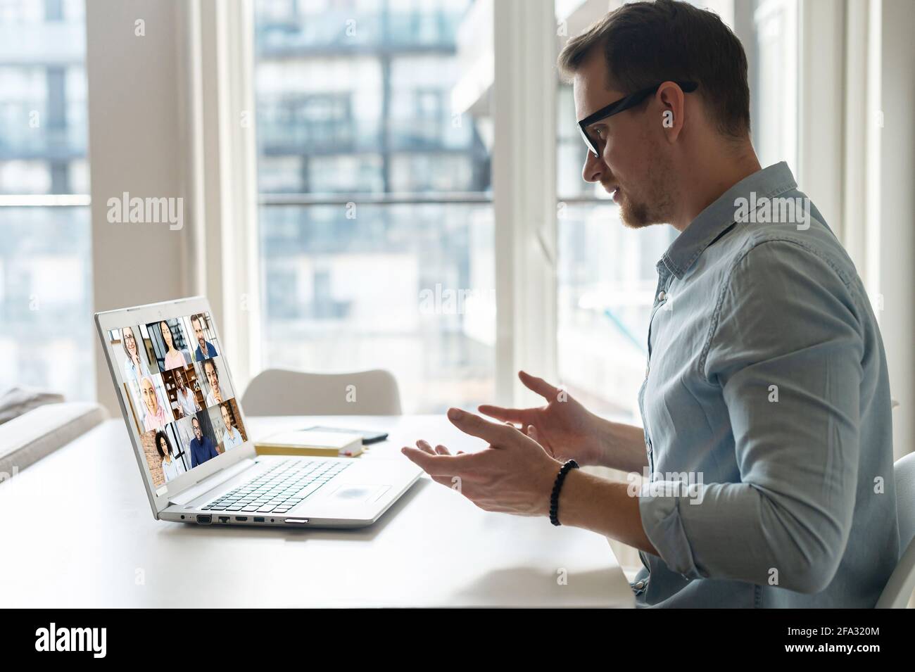 Remote morning meeting. A young man wearing smart casual shirt and ...