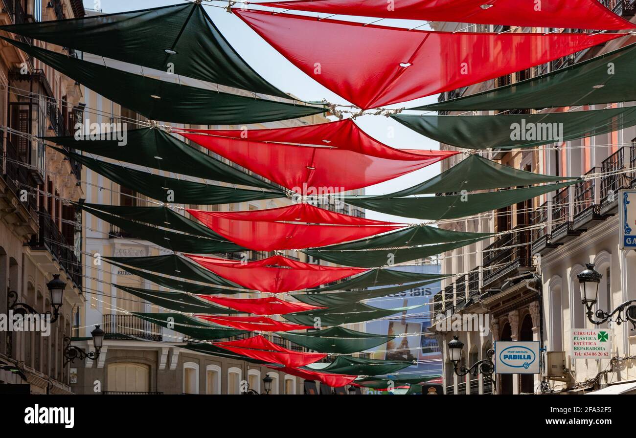 A picture of the colorful sun covers that decorate a street in Madrid ...