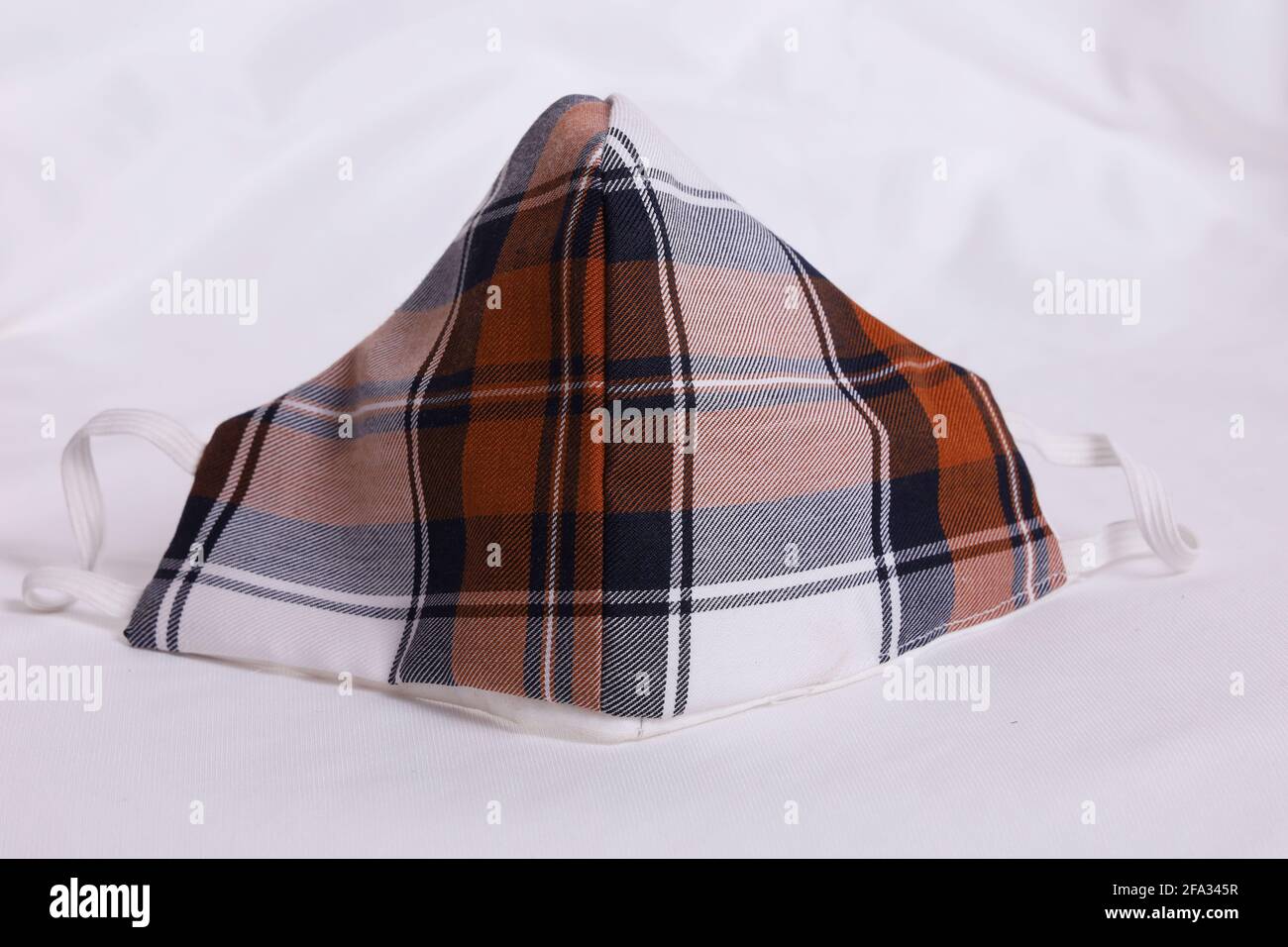 Checkered face mask on white background Stock Photo - Alamy