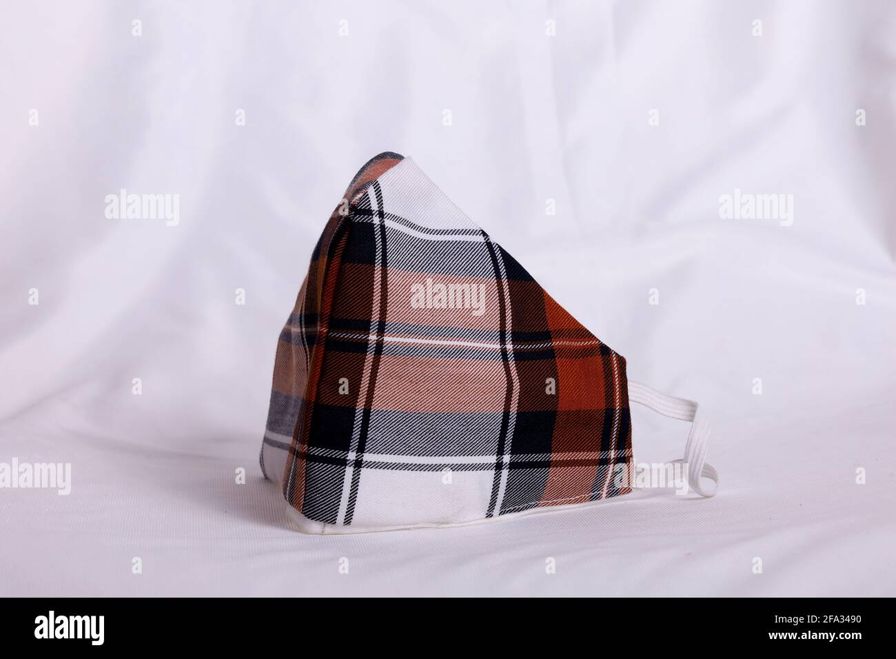 Checkered face mask on white background Stock Photo - Alamy