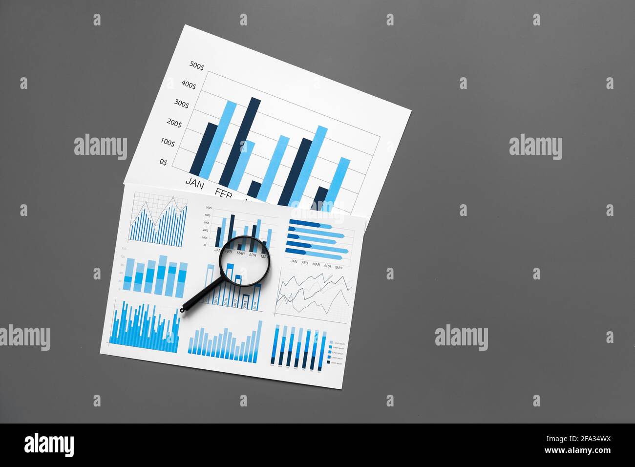 Financial paper with charts and diagrams on gray table Stock Photo - Alamy