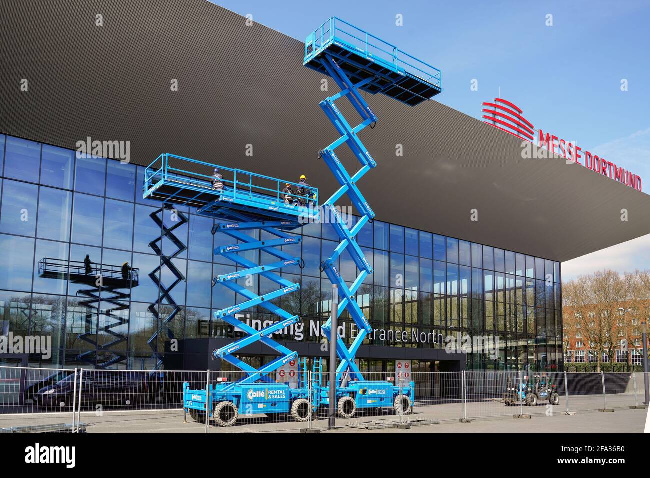 Two scissor lifts, work platforms, and lifting platforms in front of ...
