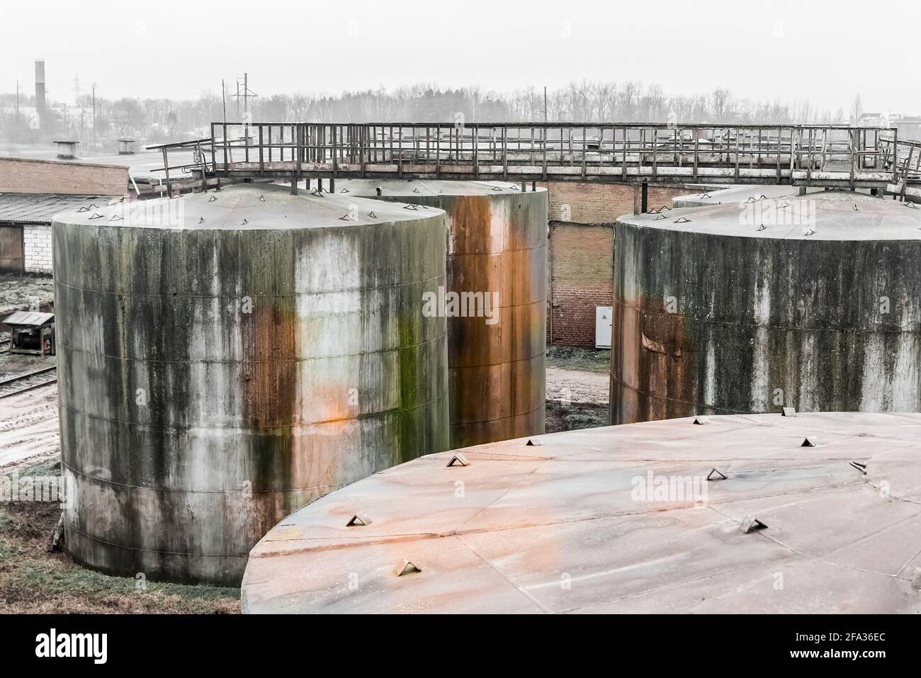 Old fuel oil tanks with fuel oil stains and traces of rust at an ...