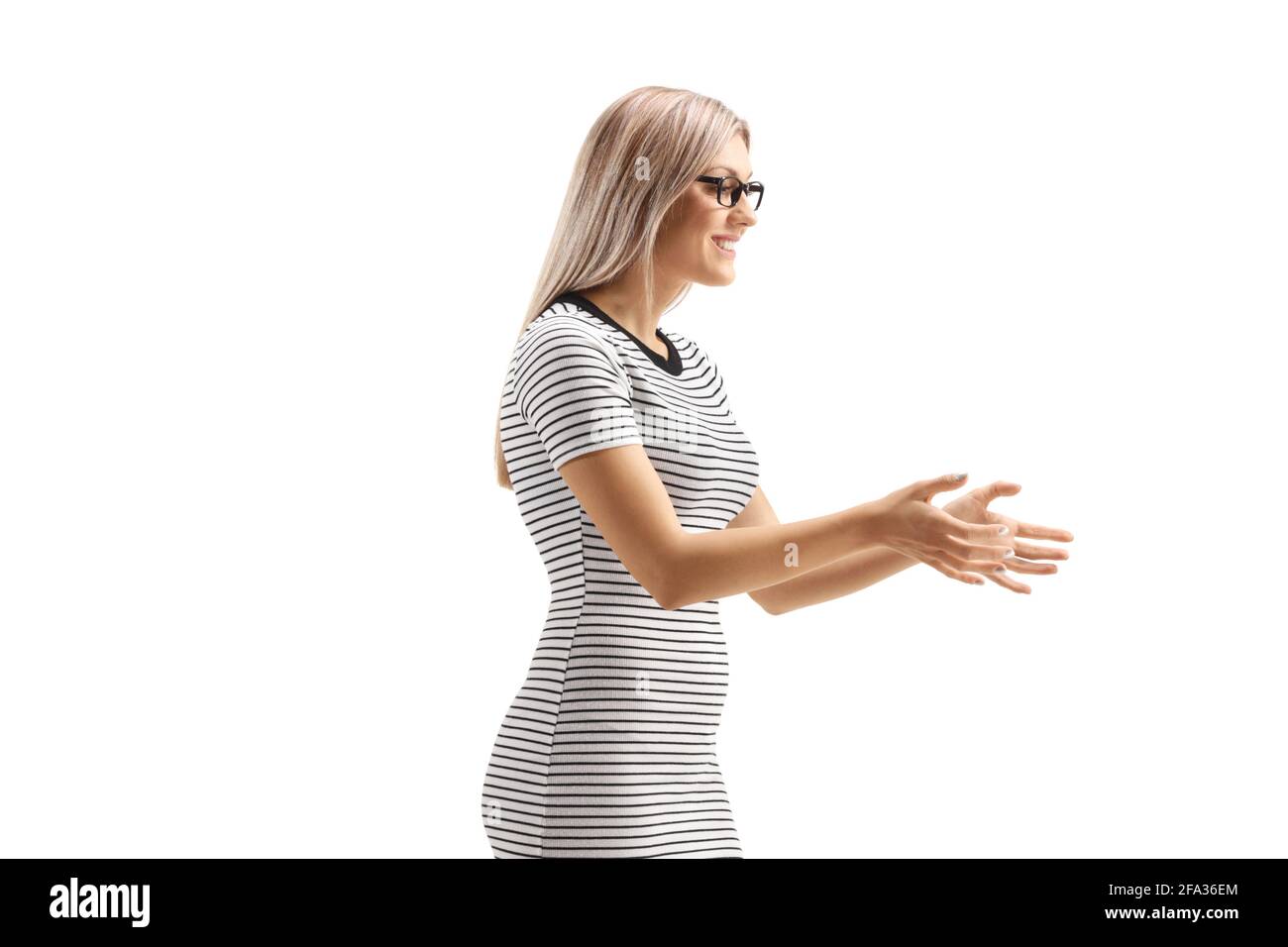 Young blond woman waiting to receive something and gesturing with hands ...