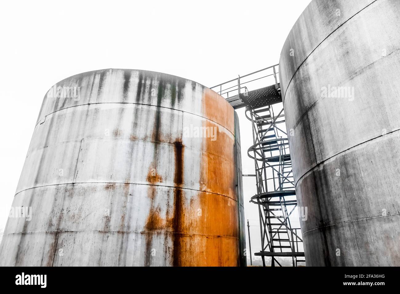 Old fuel oil tanks with fuel oil stains and traces of rust at an ...