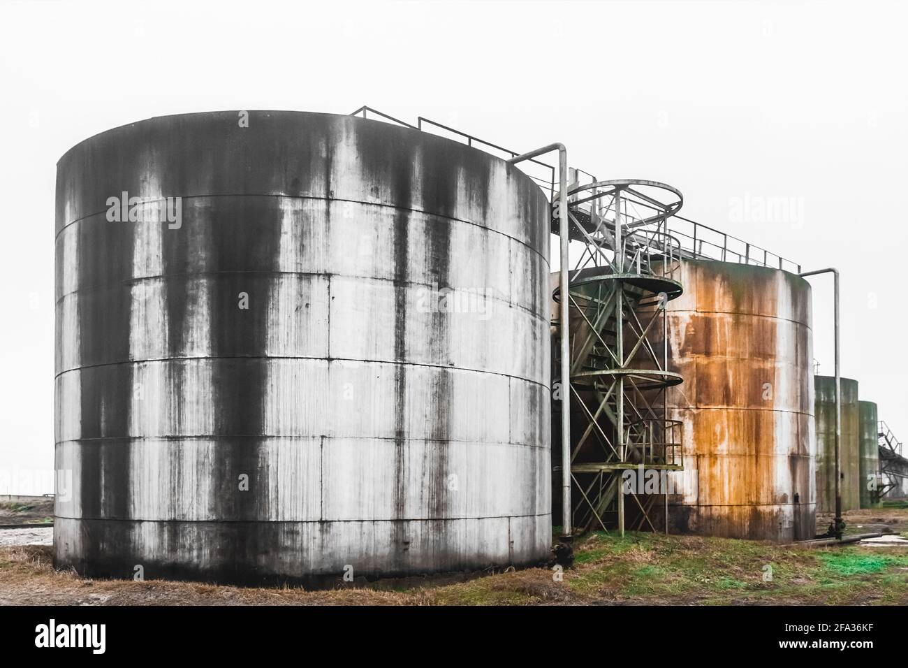 Old fuel oil tanks with fuel oil stains and traces of rust at an ...