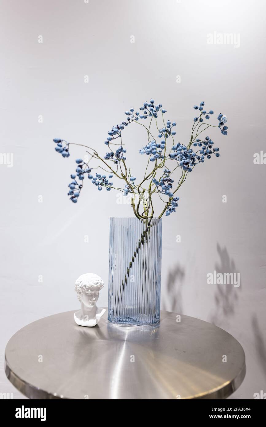 Stylish gypsum statue of David bust in living room or cafe interior ...