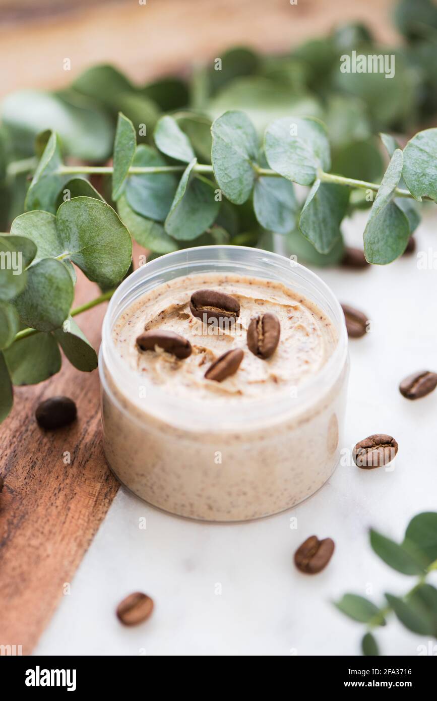 Natural body coffee scrub with eucalyptus branches on marble background ...