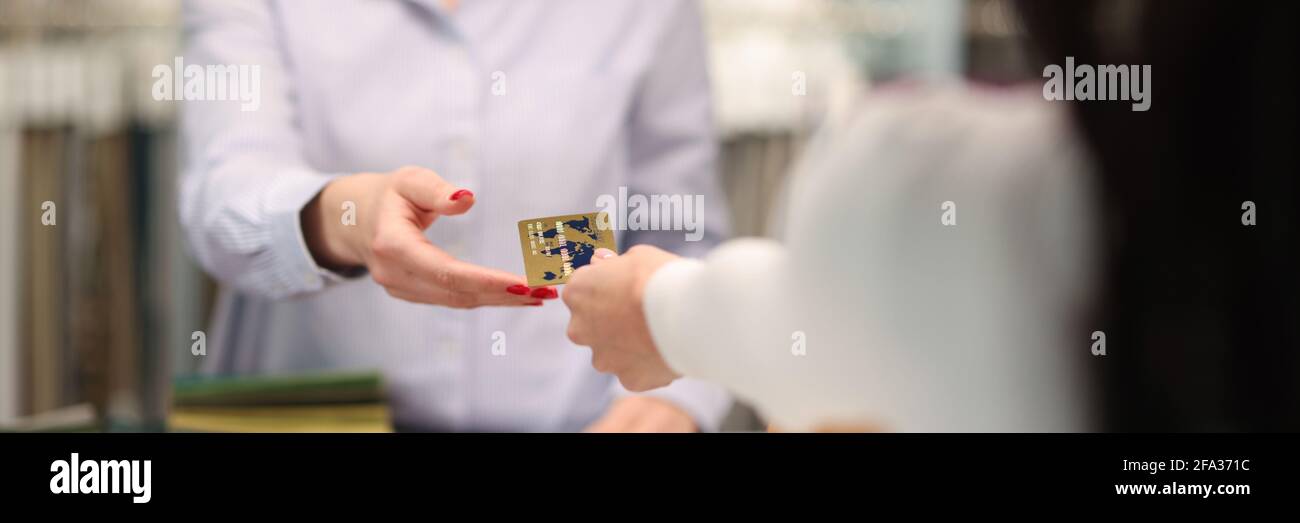 Customer handing credit bank card to sellers hand closeup Stock Photo ...