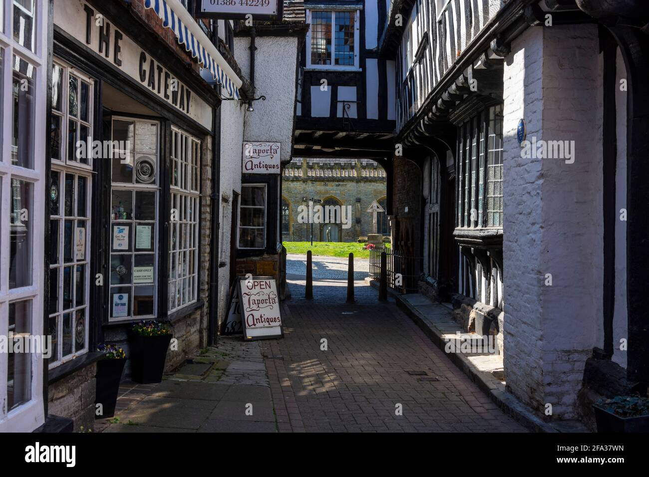 Evesham market place with the Abbey seen through the archway showing ...