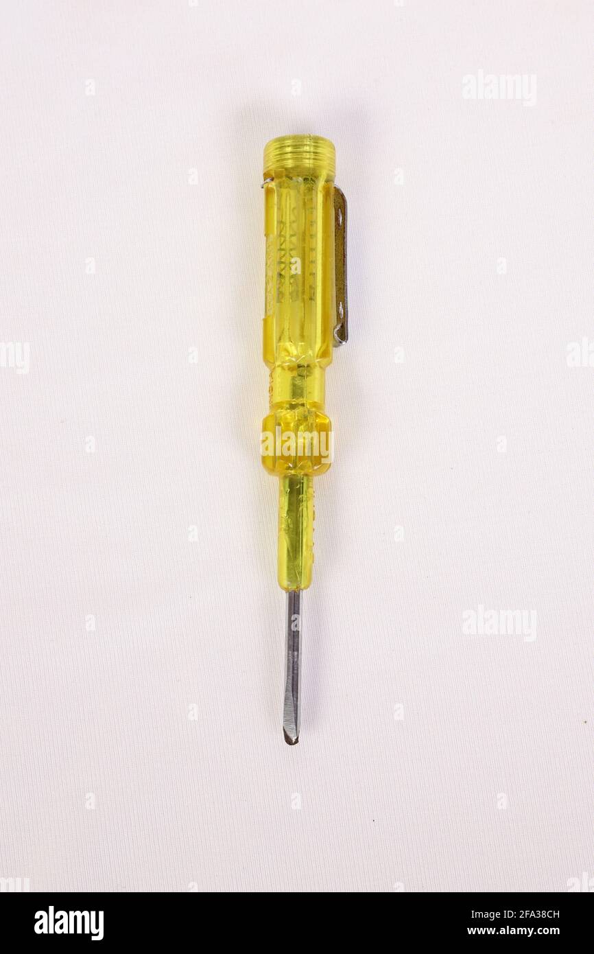 Vertical shot of a yellow screwdriver isolated on white background ...