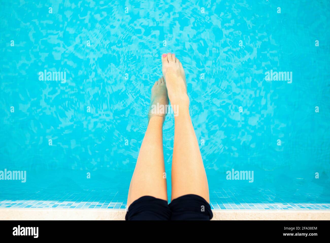 Woman sitting edge pool legs hi-res stock photography and images - Alamy