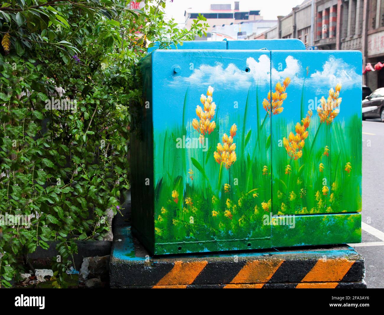 An electric transformer utility cover colorfully painted to look like a ...