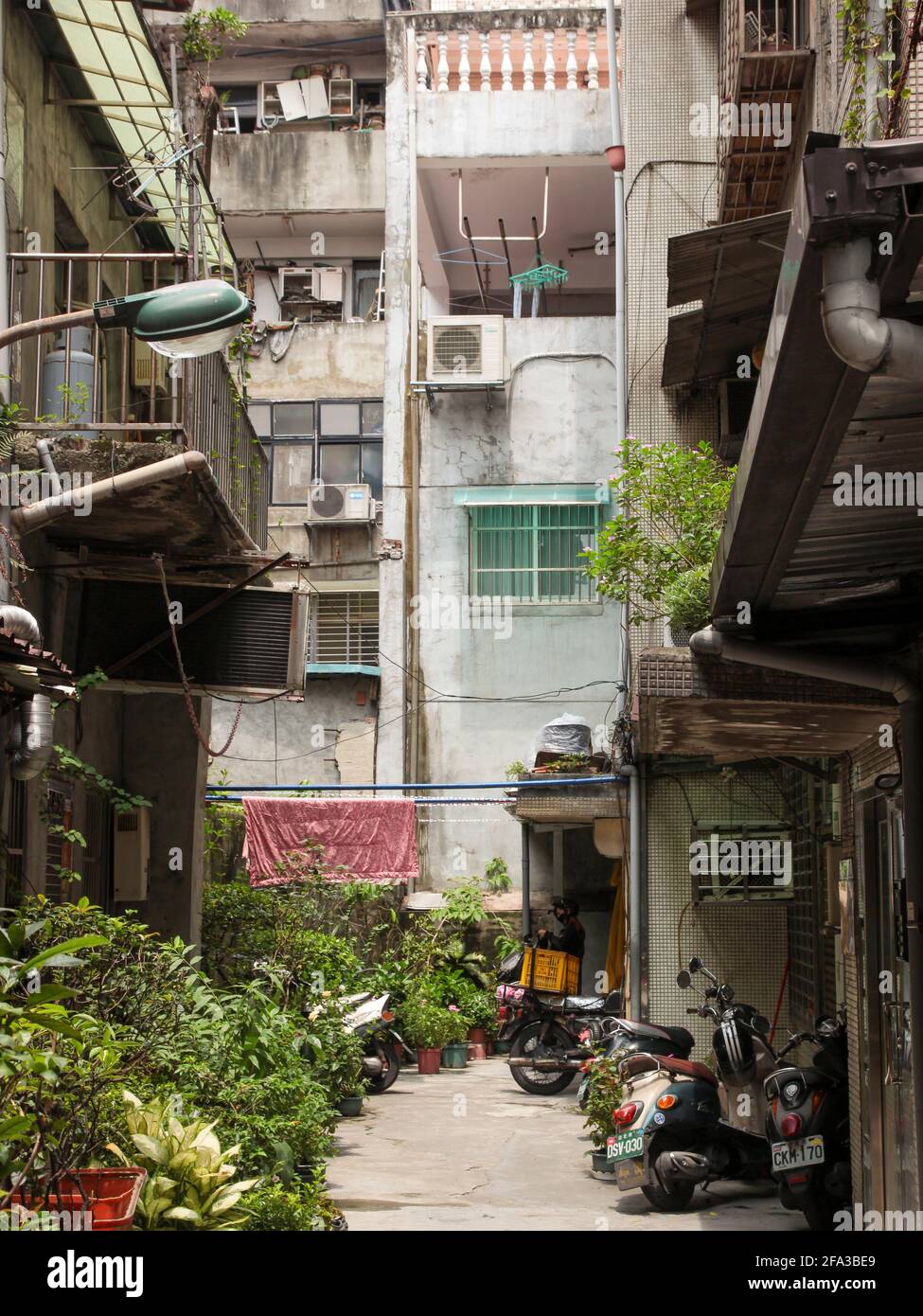 Looking at some old apartment buildings with balcony bars and garden ...