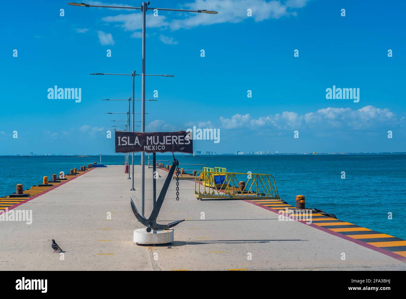 The pier from Isla Mujeres with the signe, background the sea and ...