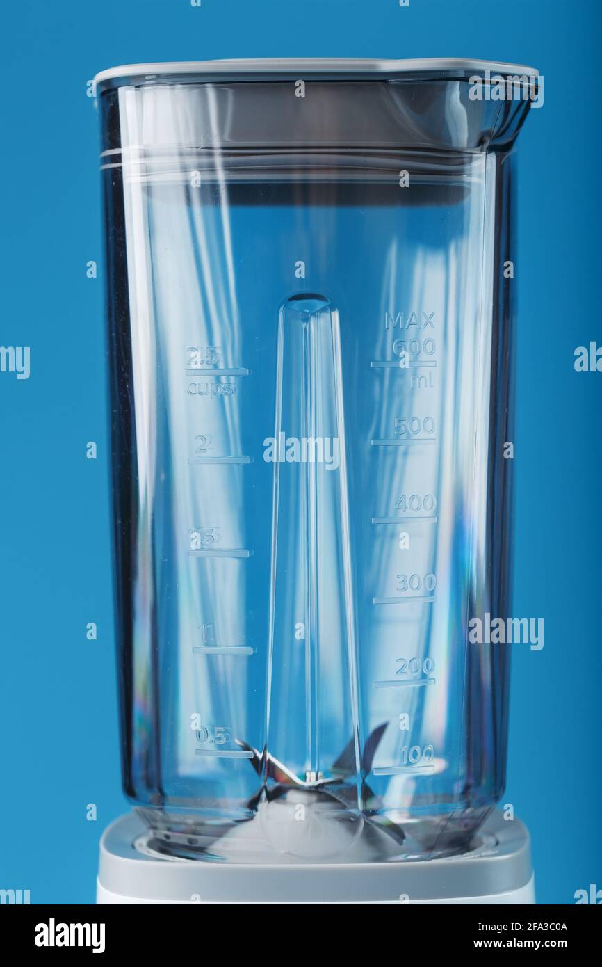 Electric blender with an empty cup on a blue background. Free space ...