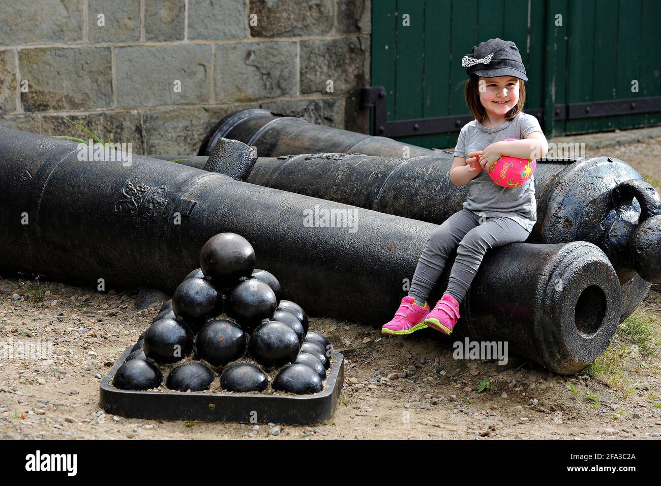 little girl sits on cannon in Quebec city Stock Photo - Alamy