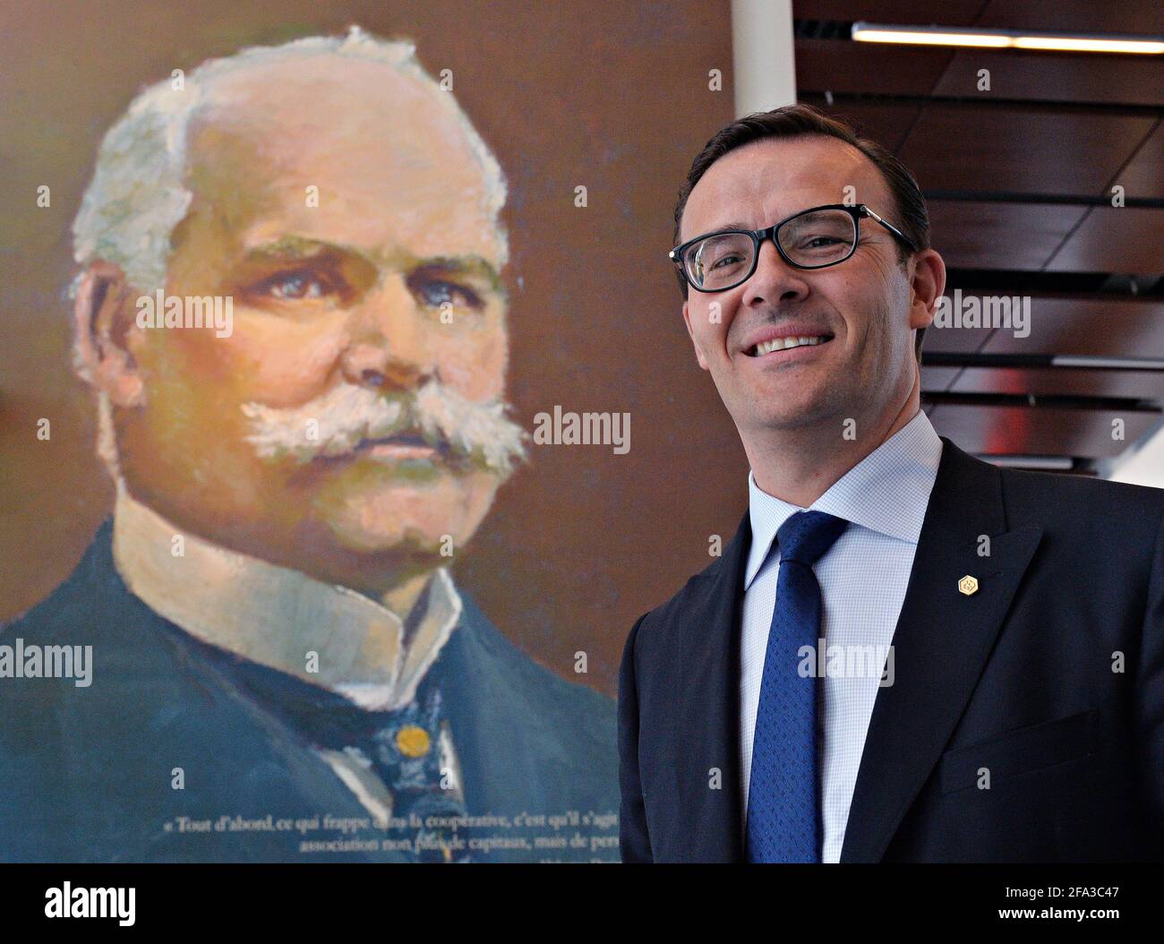 Guy Cormier president of Mouvement Desjardins with an image of the ...