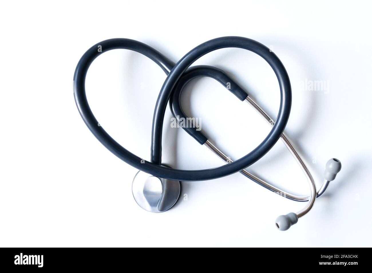 Stethoscope forming a heart on white background Stock Photo - Alamy