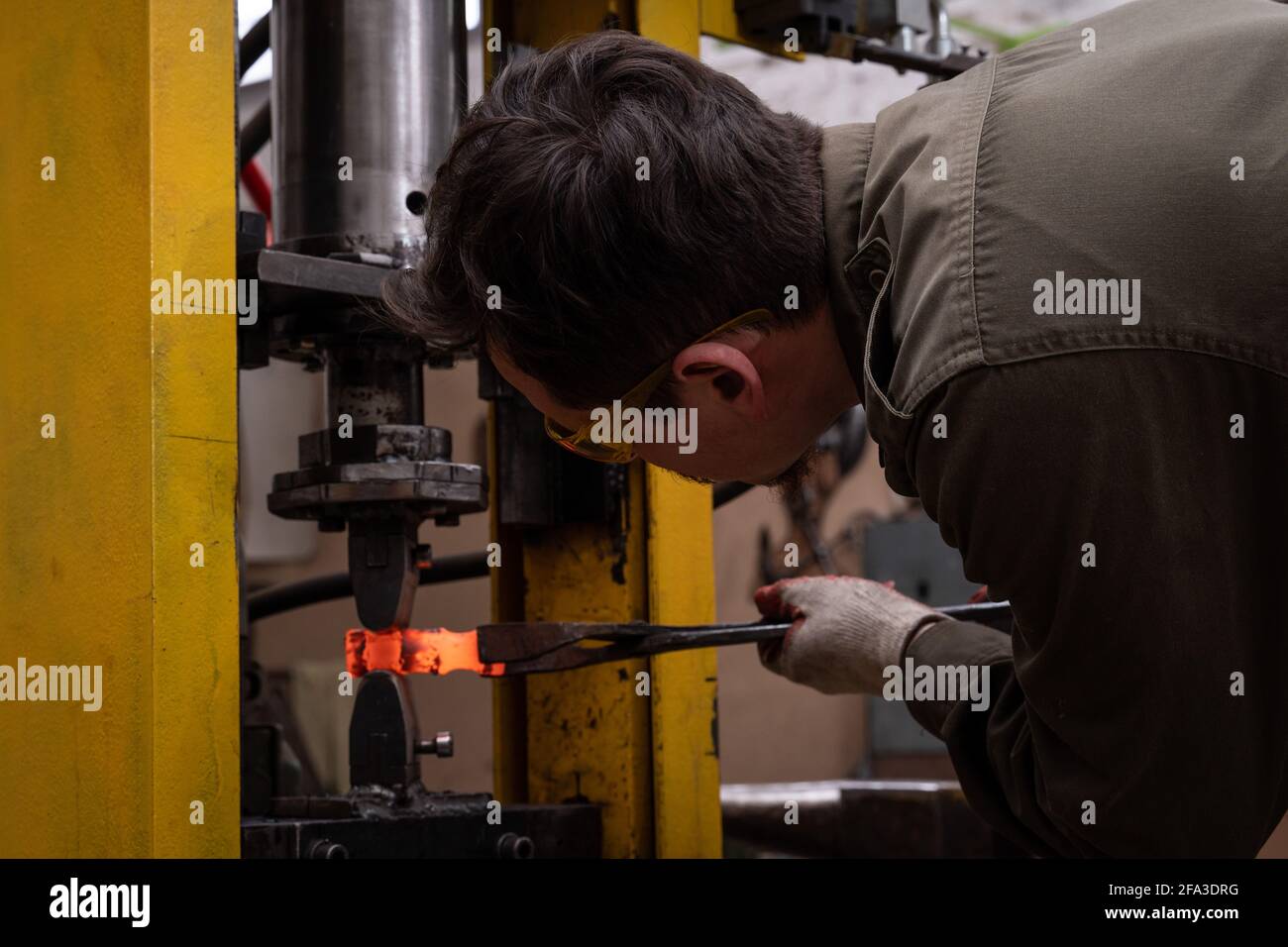 Traditional metalworking process in a forge. Close-up of machining a ...