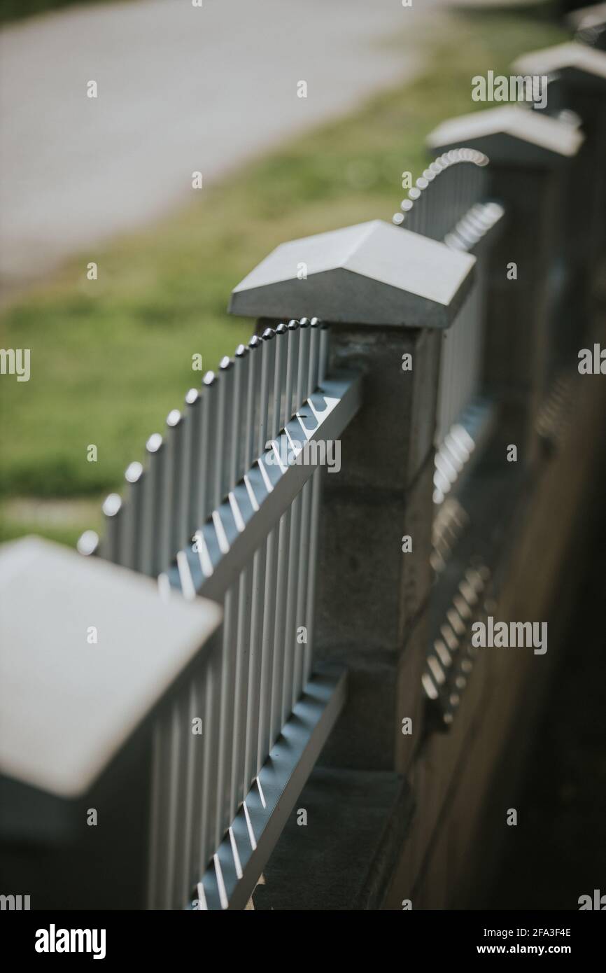 Long transparent metal fence with concrete pillars Stock Photo - Alamy