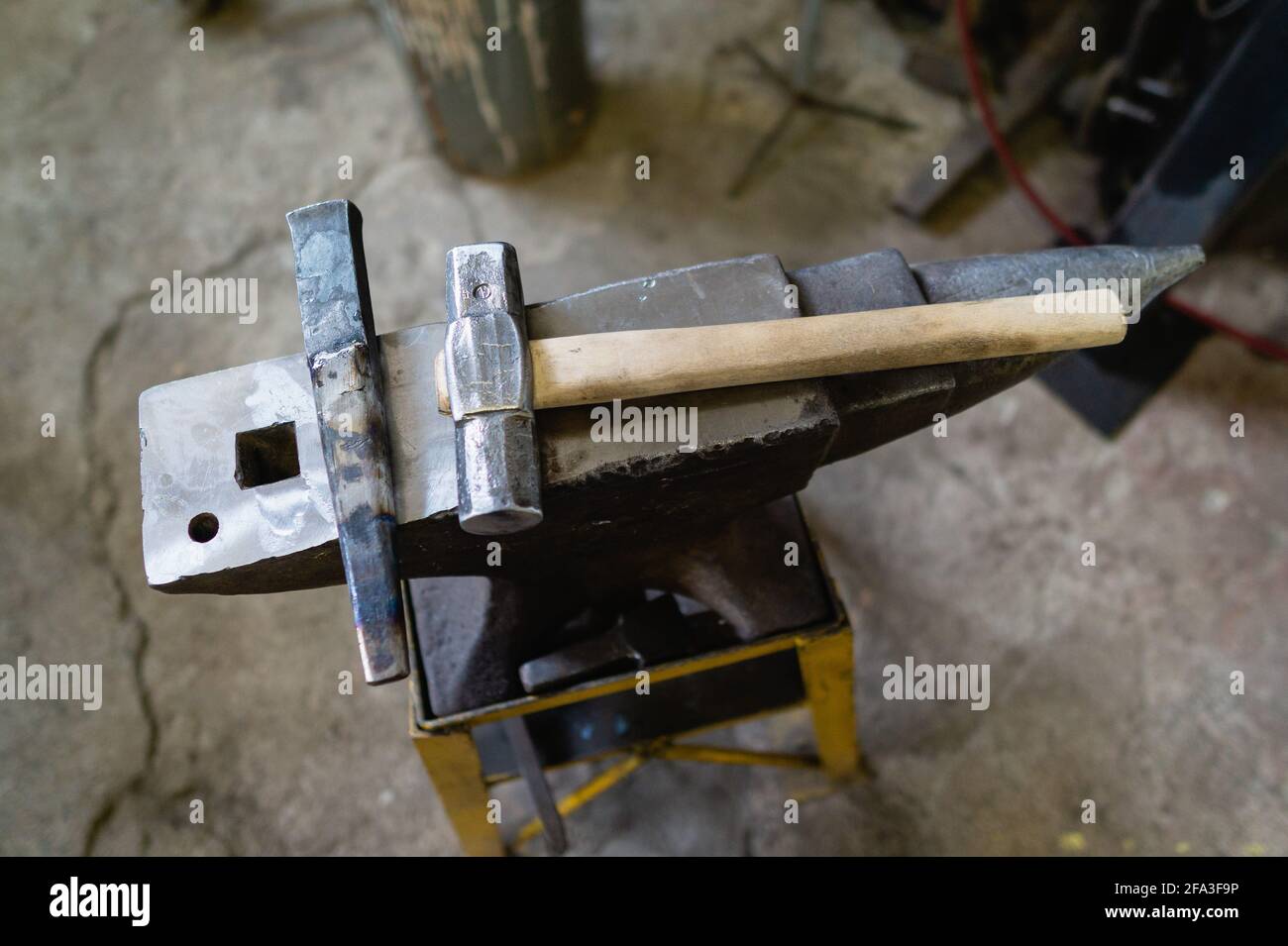 Tools for forging in a blacksmith shop. The hammer lies on the anvil ...