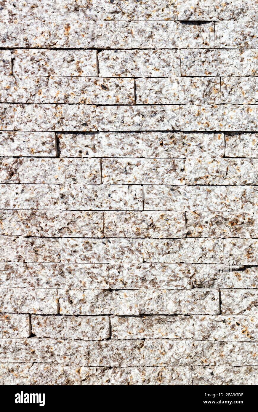 Wall background and texture with gray granite tiles with beige splashes ...