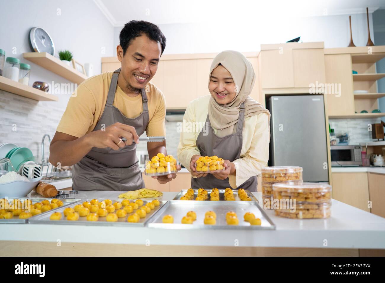 muslim couple making nastar snack cake together in the kitchen during ...