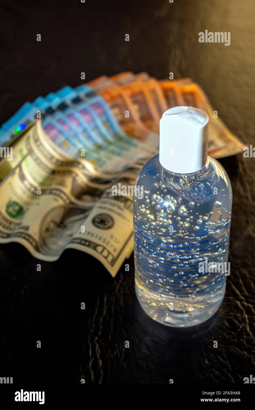 Gel alcohol and cash (dollars and euros Stock Photo - Alamy