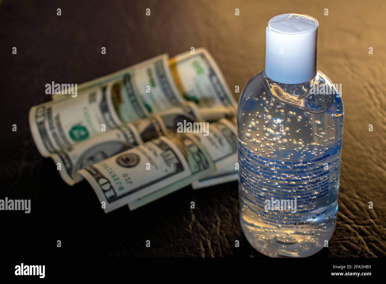 Gel alcohol and cash (dollars Stock Photo - Alamy
