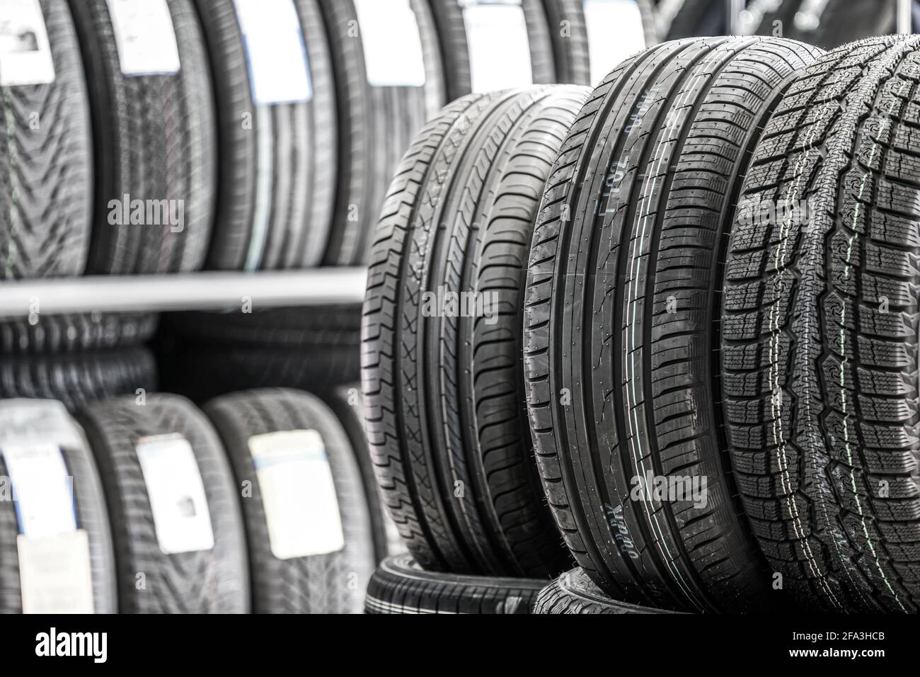 various new tires in the service shop against the blurred tire ...
