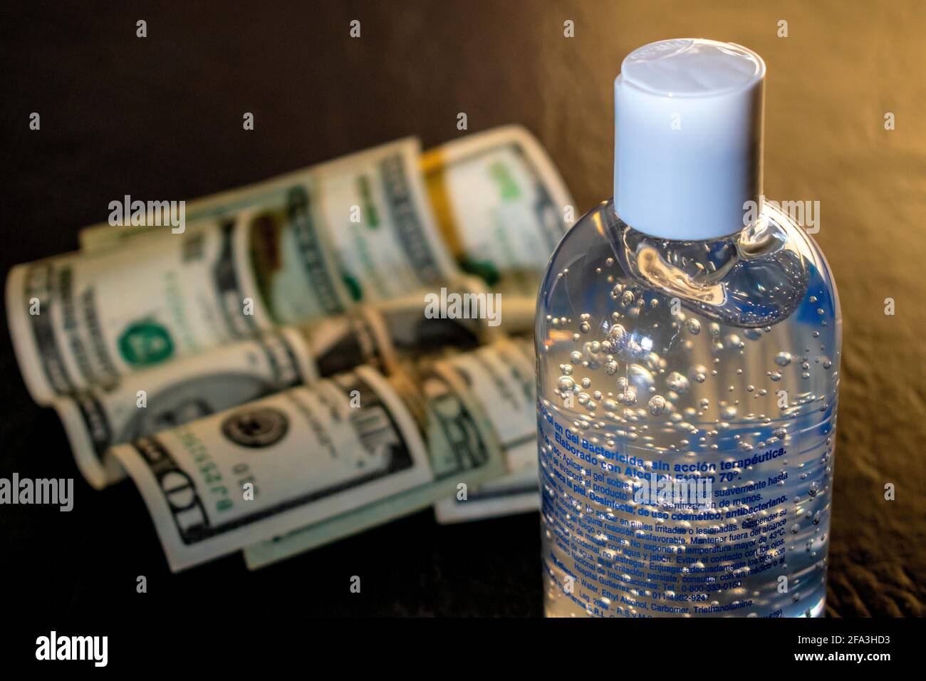 Gel alcohol and cash (dollars Stock Photo - Alamy