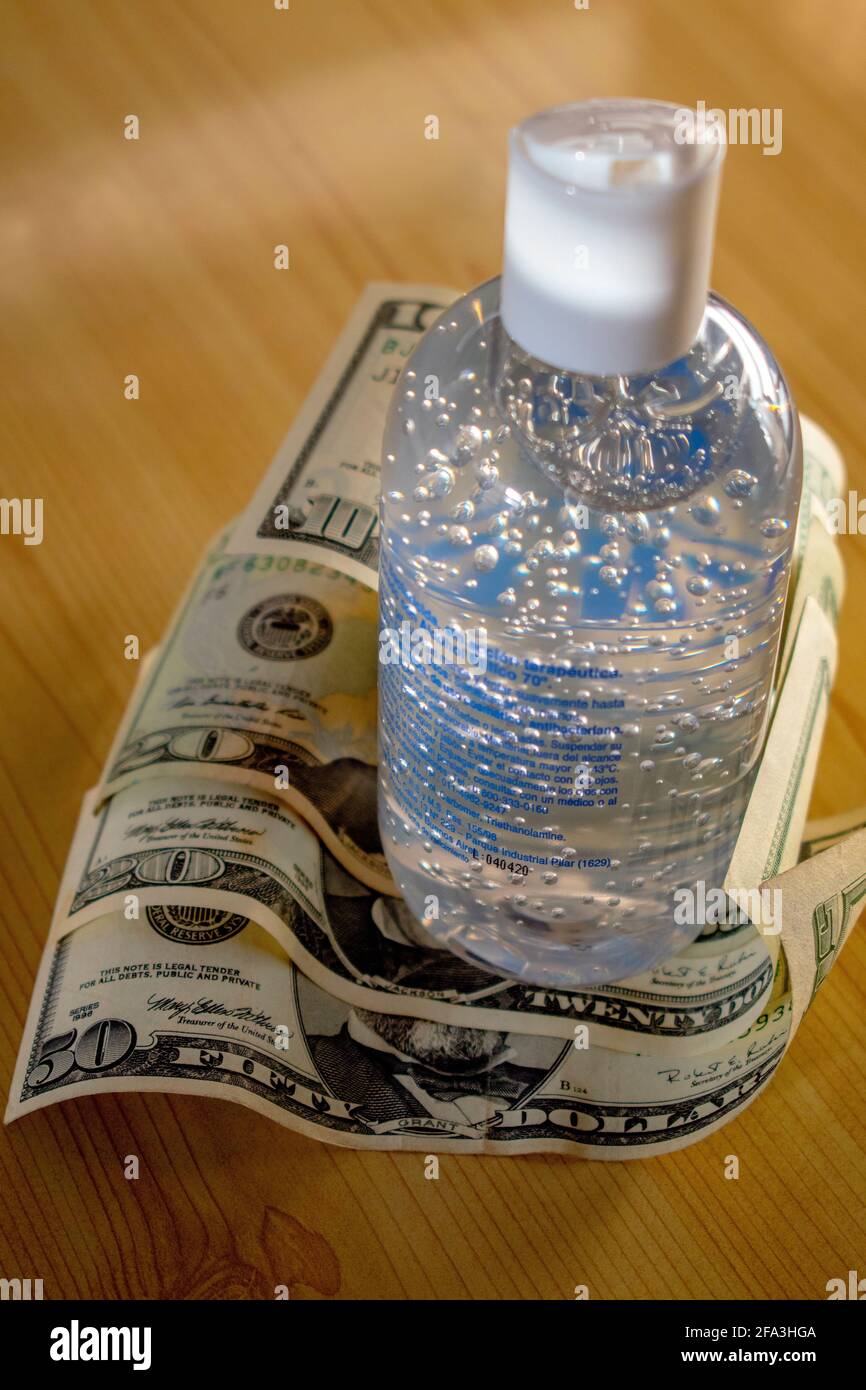 Gel alcohol and cash (dollars Stock Photo - Alamy