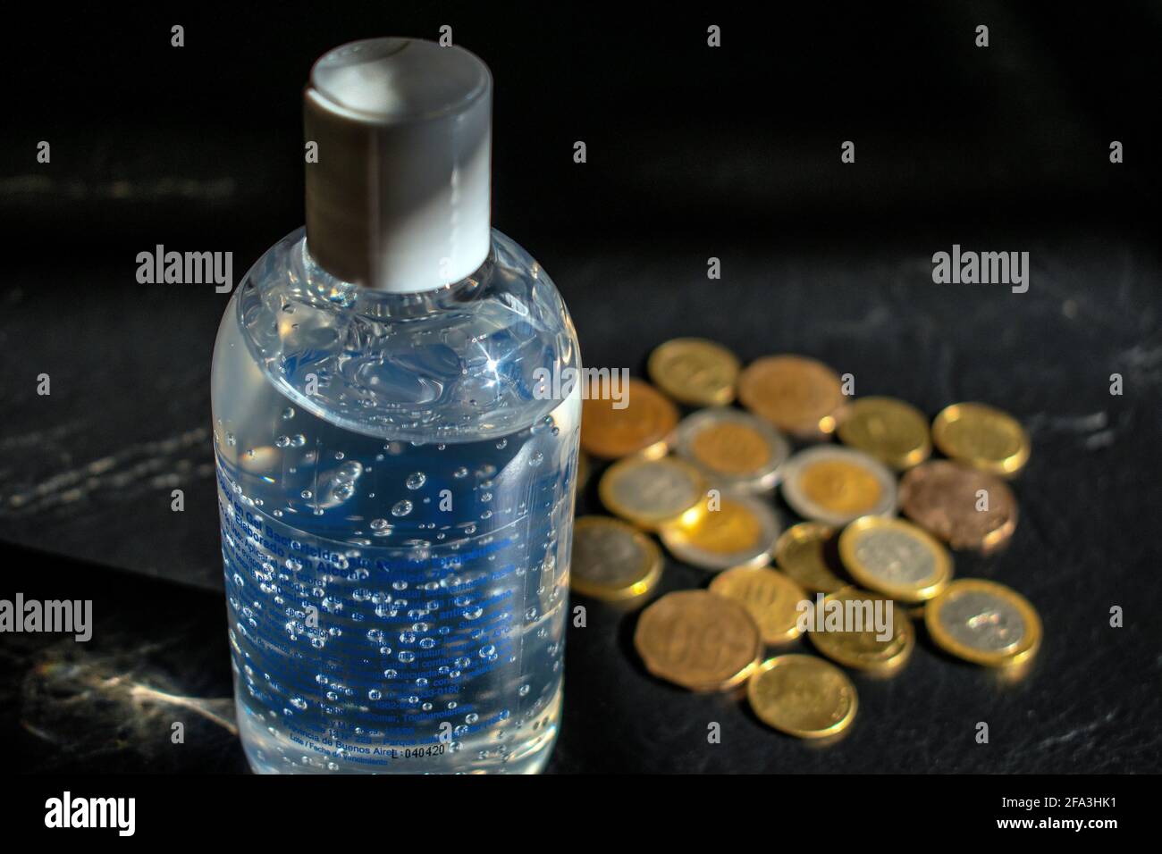 Gel alcohol and cash (coins Stock Photo - Alamy