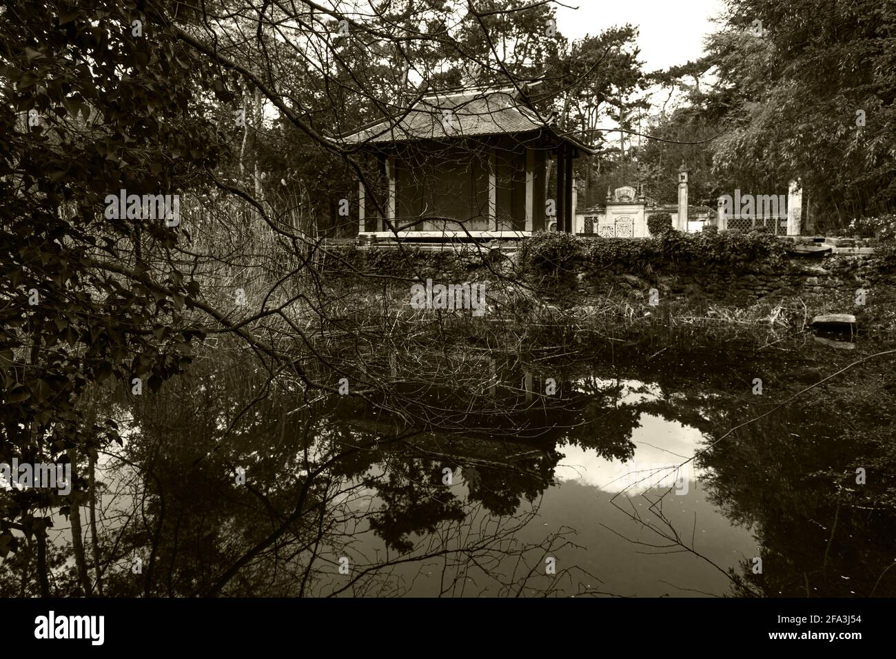 Indochinese temple of remembrance. Red temple over the pond with ...