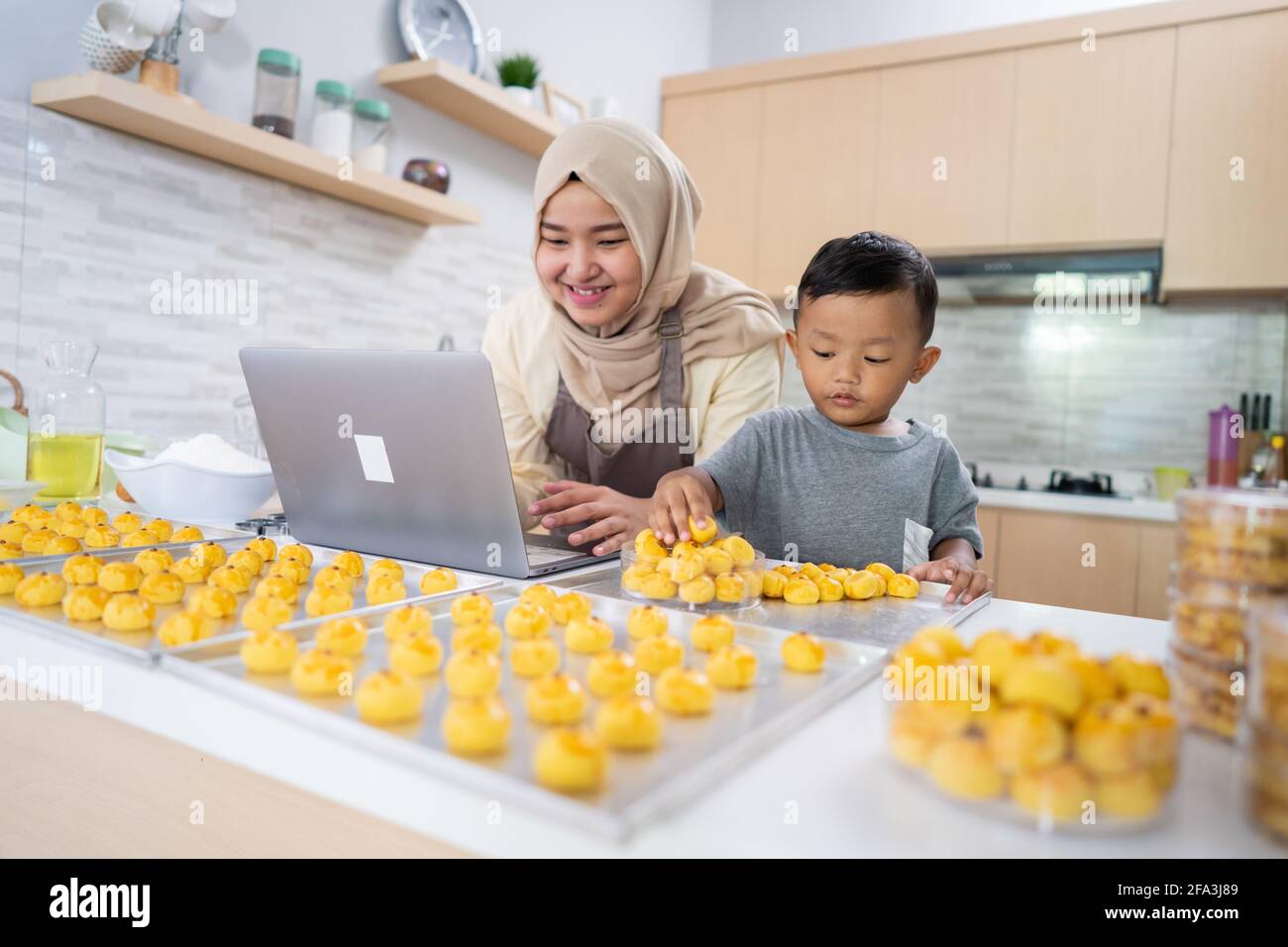 muslim mother working from home making food order of nastar pineapple ...