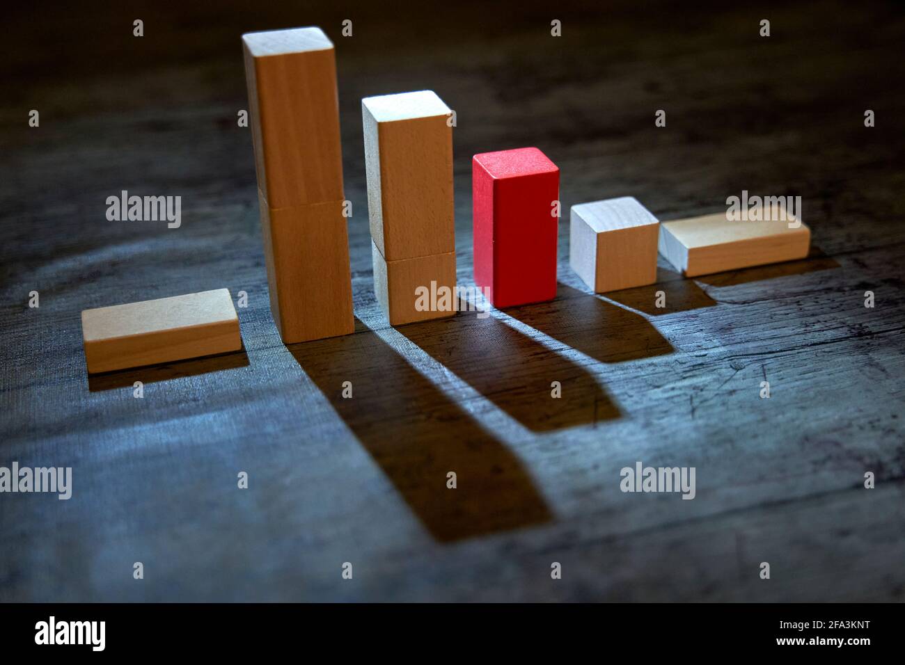 Set of wooden blocks in the form of a losing graph with a red block ...