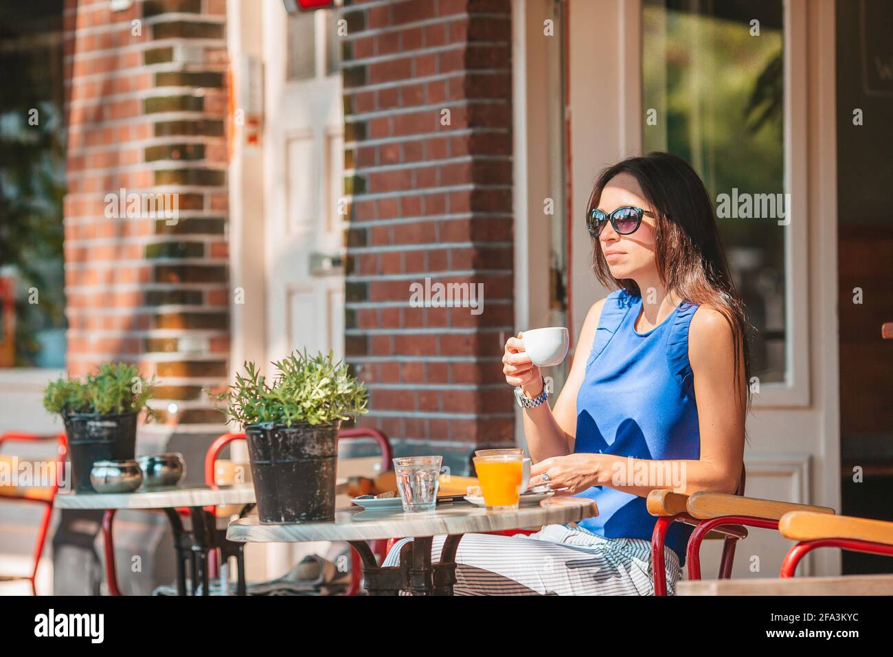 Woman having breakfastin outdoor restaraunt Stock Photo - Alamy